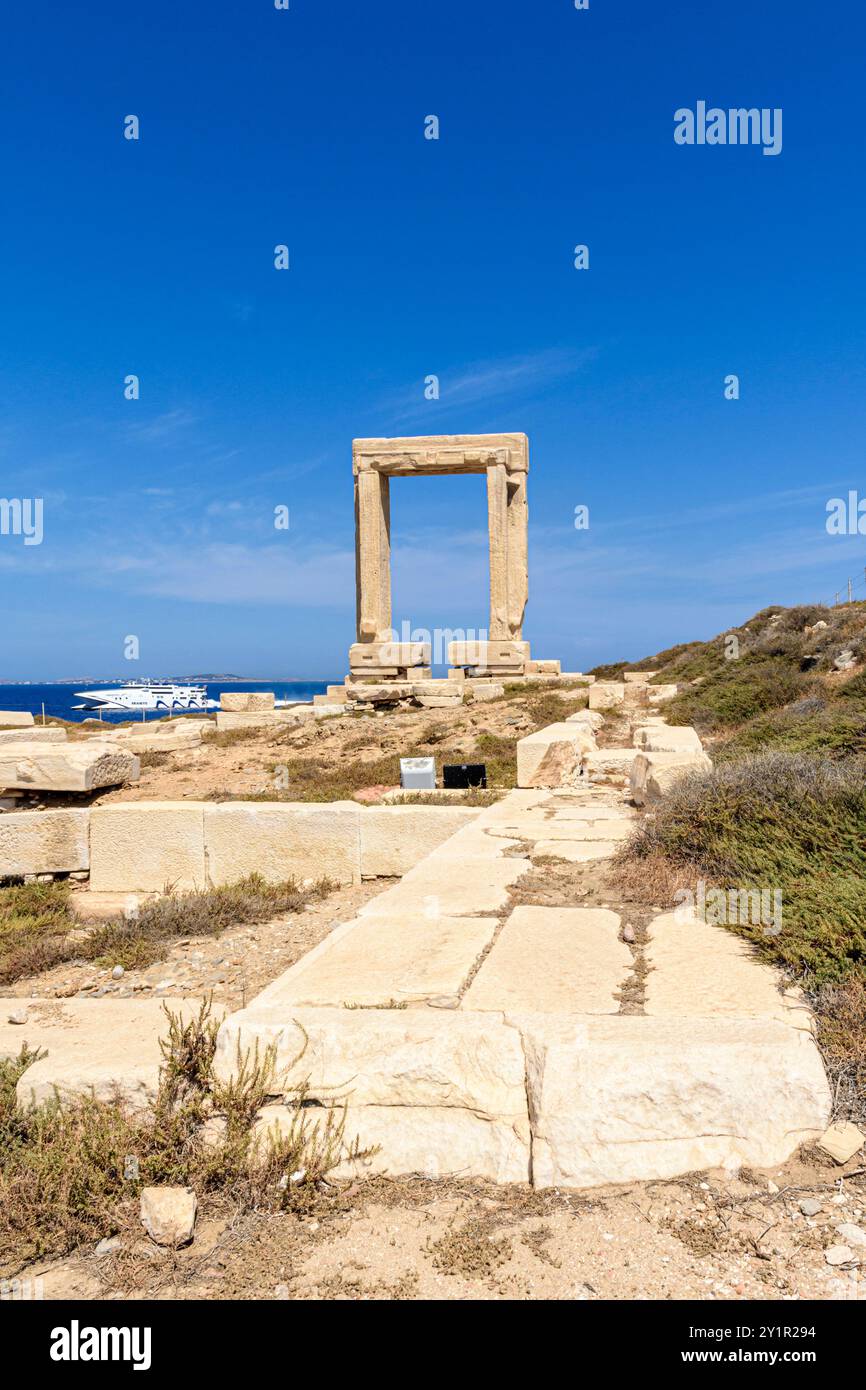 A Greek ferry trimaran speeds past the Temple of Apollo Arch, Naxos ...