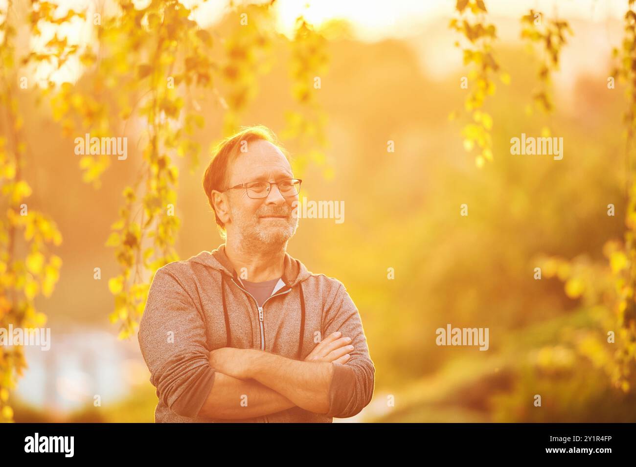 Outdoor portrait of 50 - 55 year old man enjoying nice bright morning ...