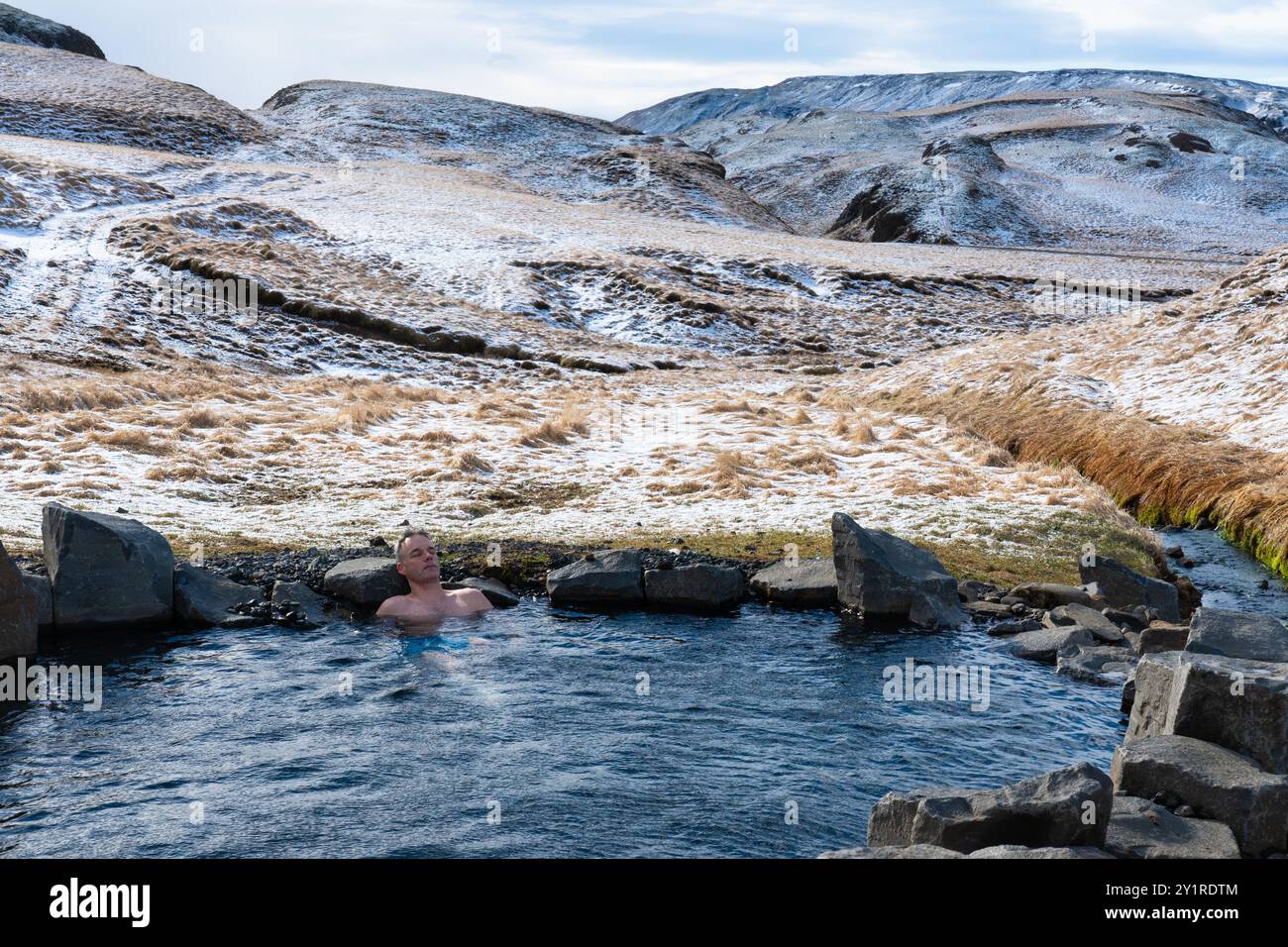 Caucasian man enjoying hot springs in a natural pool in Iceland in ...