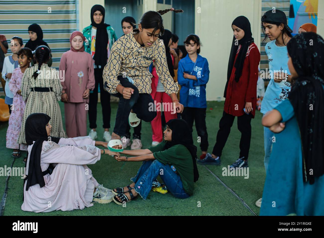 08 September 2024, Iraq, Baghdad: Children play outside the Hope Bus, a ...