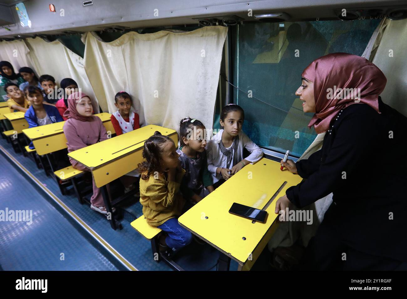 08 September 2024, Iraq, Baghdad: Children attend a class inside the ...