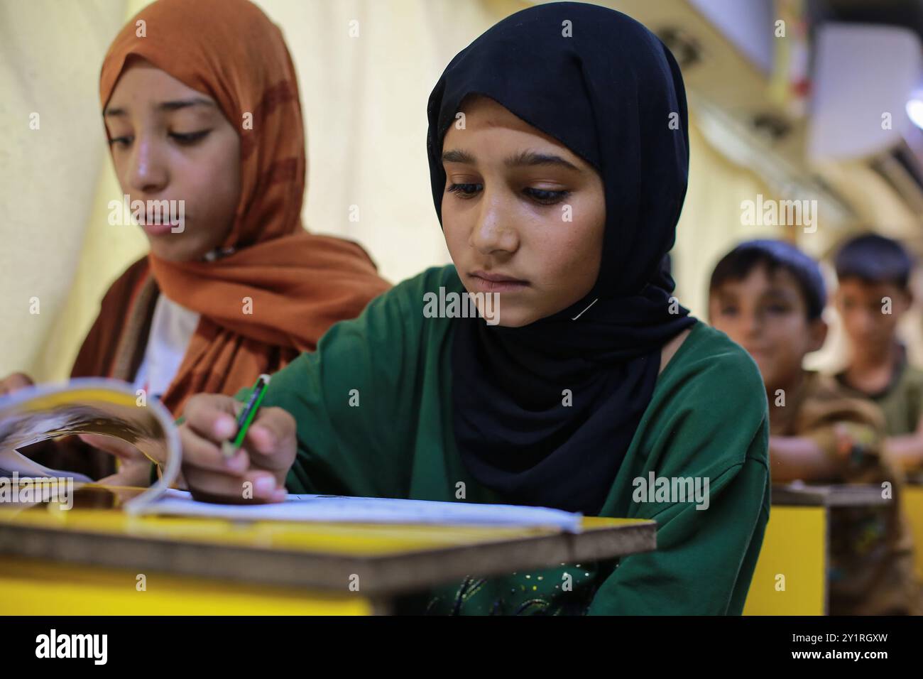 08 September 2024, Iraq, Baghdad: Children attend a class inside the ...