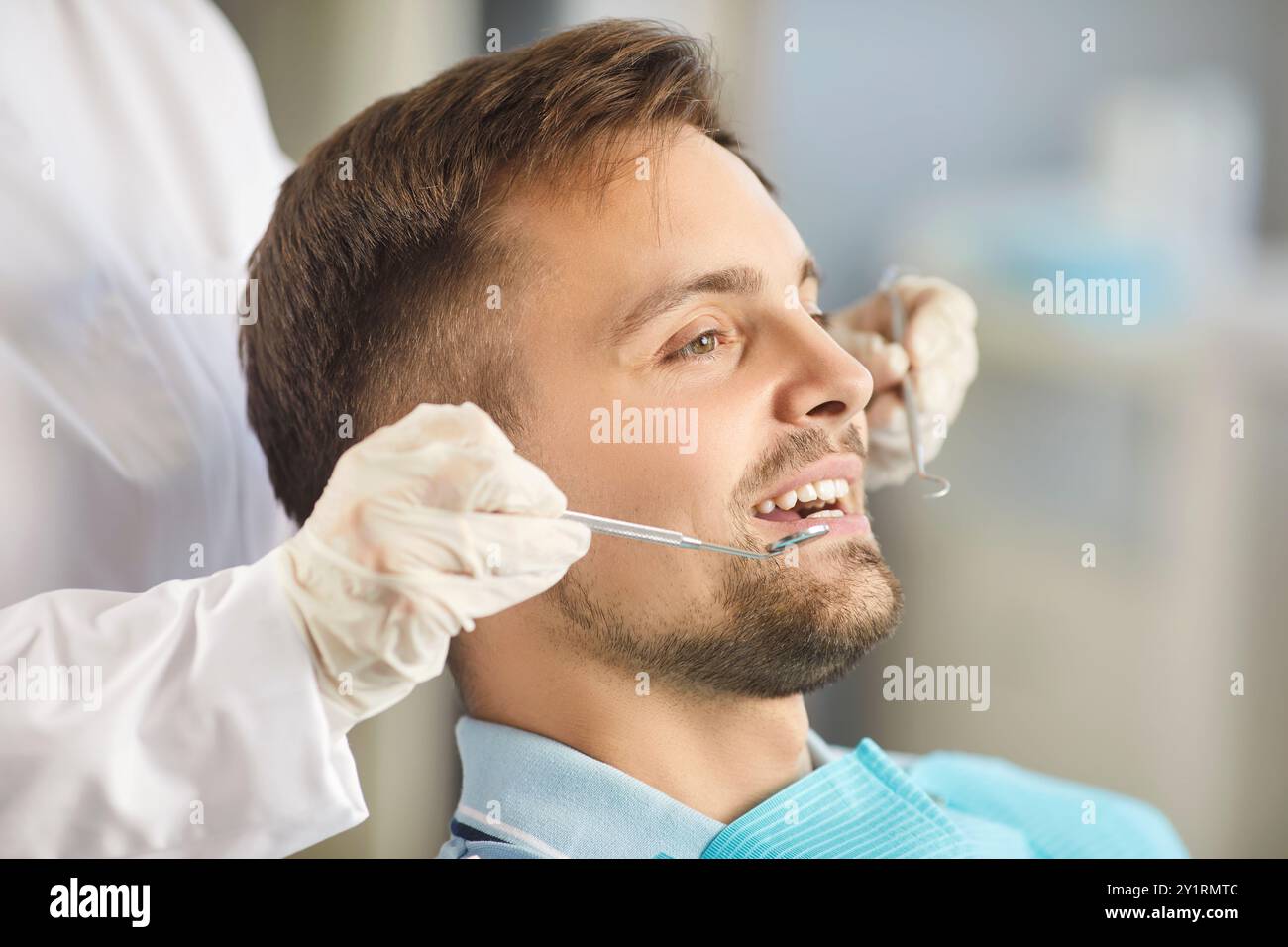 Dentist Performing Teeth Checkup with Instrument Stock Photo - Alamy