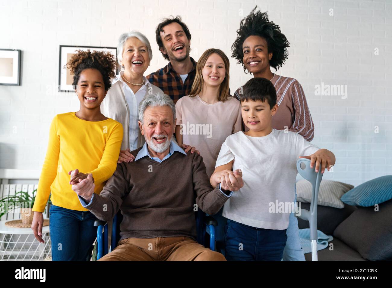 Multi generation, multiethnic family at home together, grandfather with ...