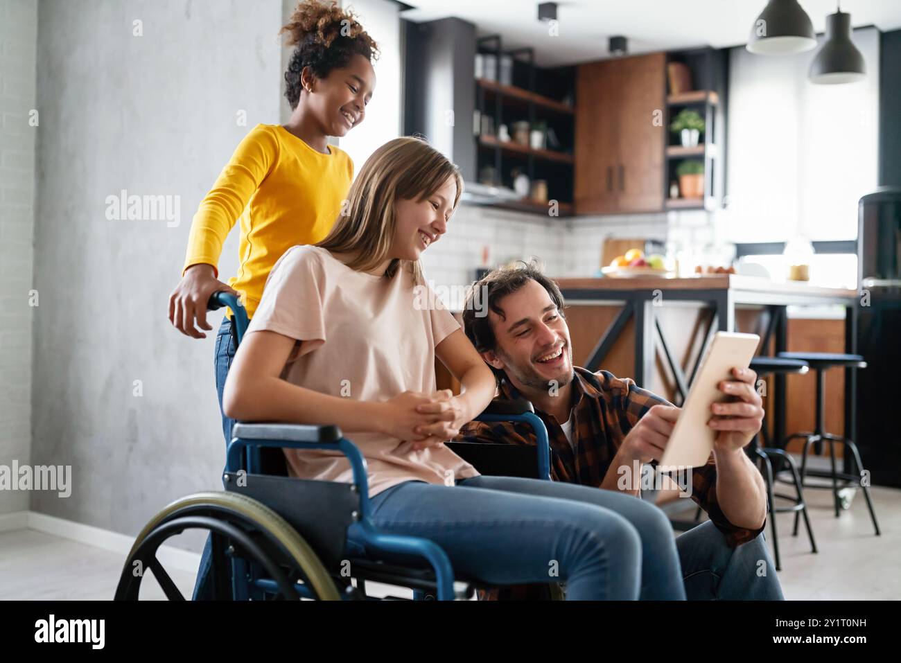 Happy multiethnic family with child with disability in wheelchair Stock ...