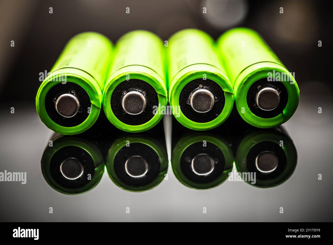 A close-up view of bright green AAA batteries showcasing advanced power ...