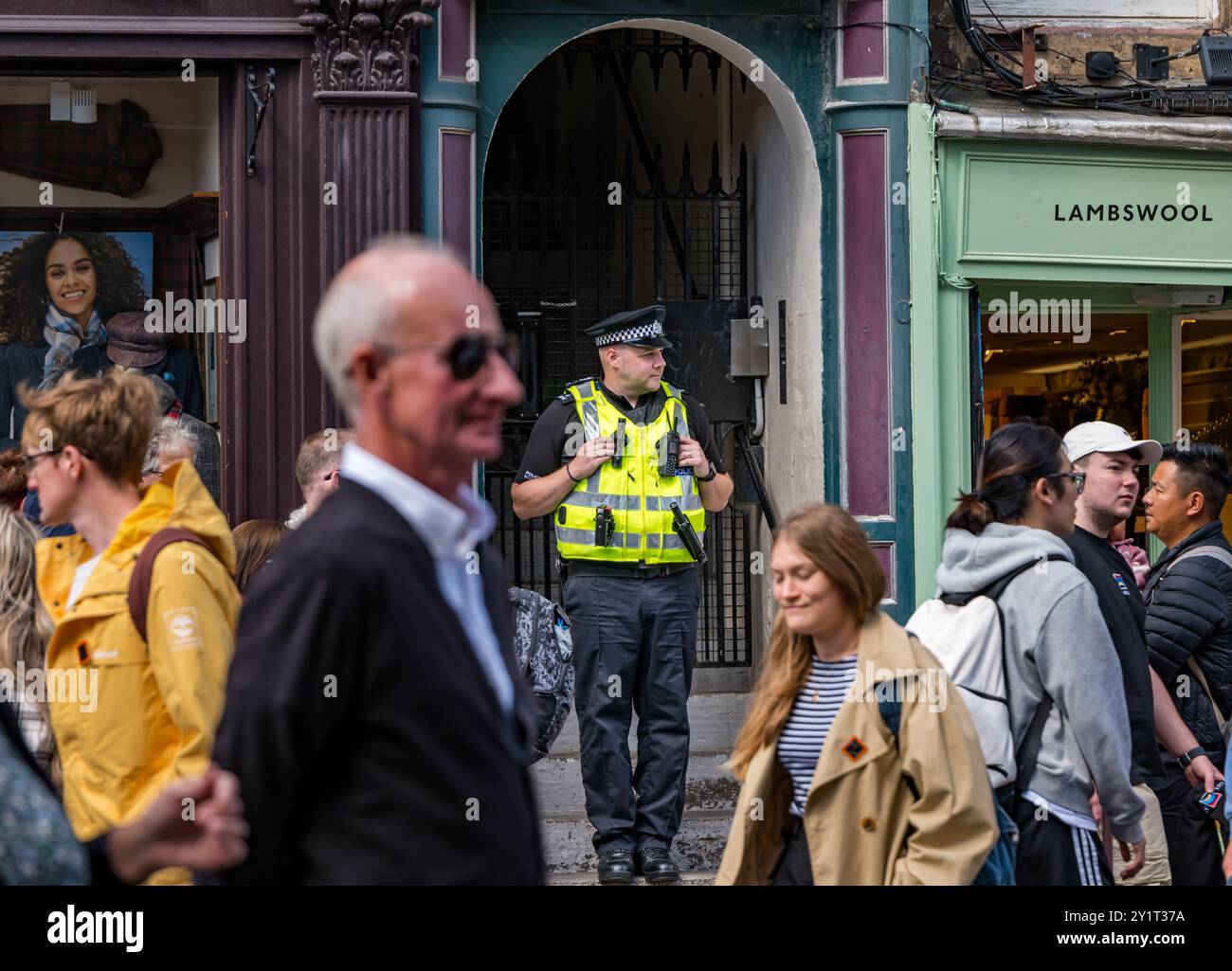 Police officer watching people on Royal Mile during Edinburgh Festival ...