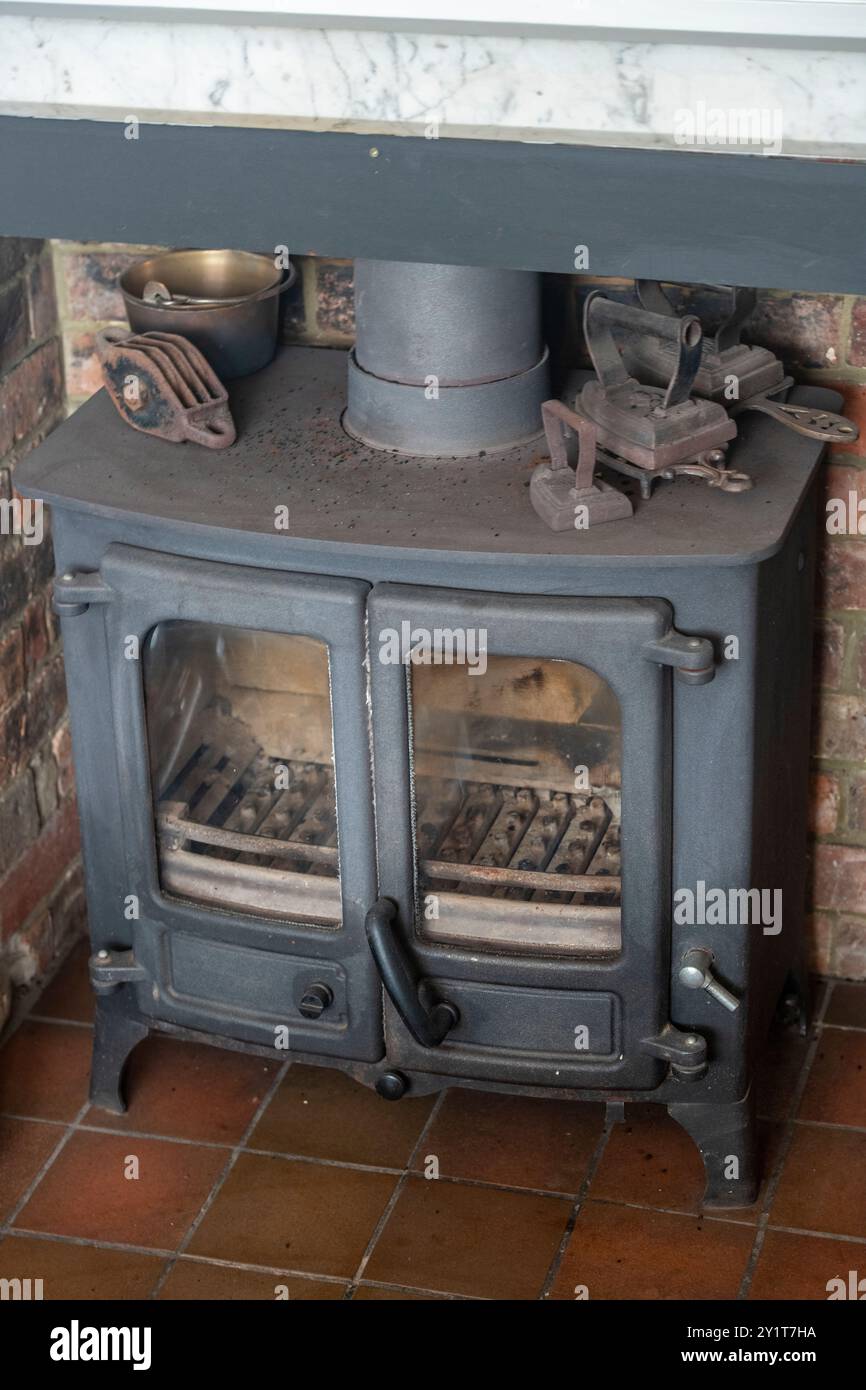 woodburning stove installed in a brick fireplace for domestic heating ...