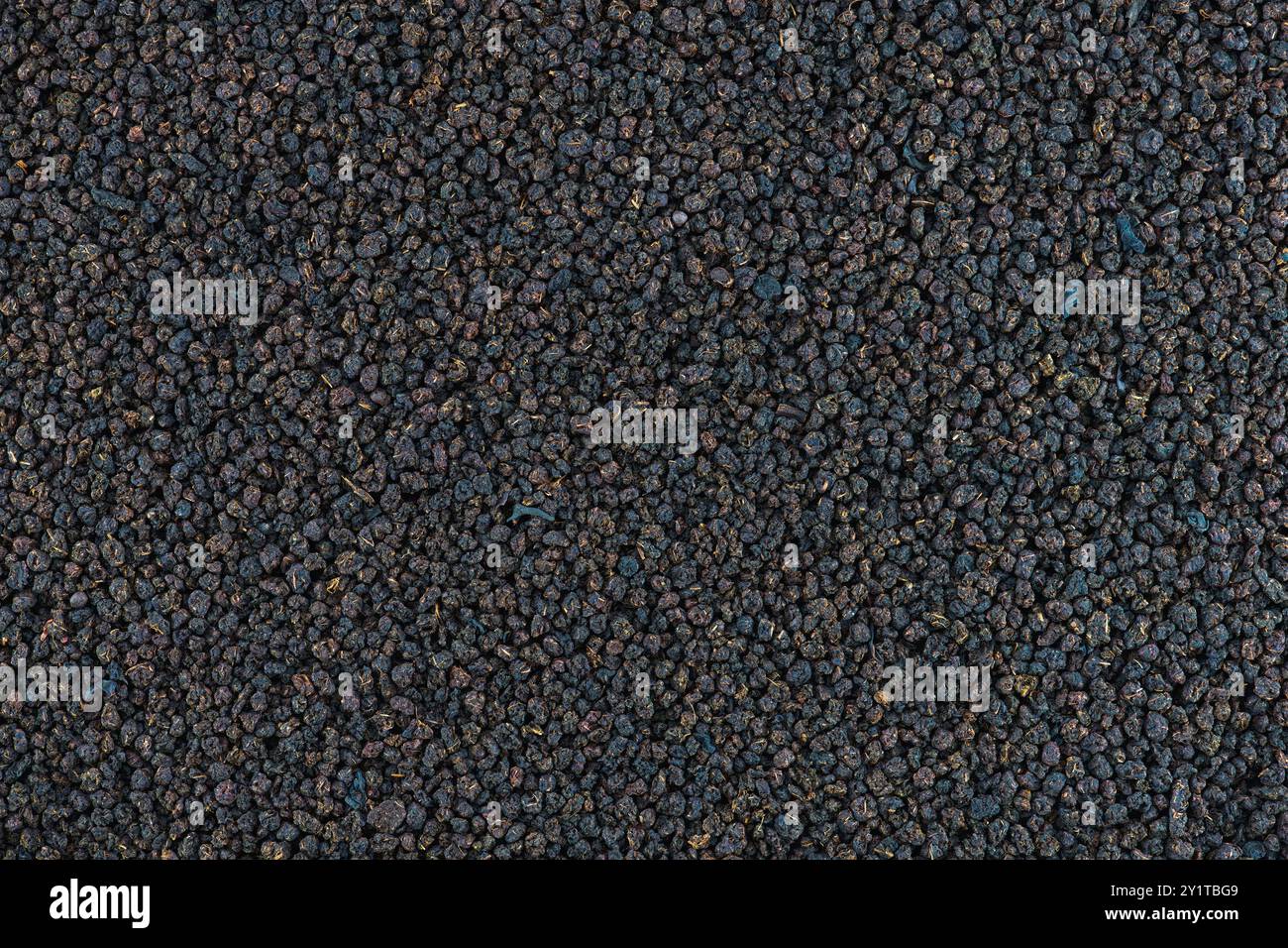 Black tea granulated texture. Indian black tea granules assam texture or background, close-up ...