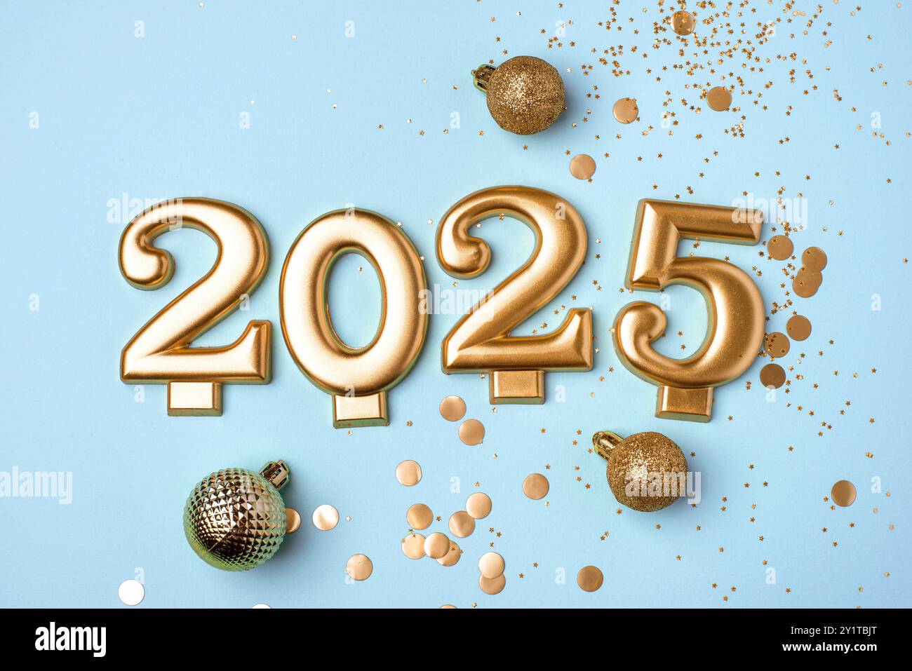 Golden 2025 on a blue color background with confetti and bokeh lights. Happy New Year 2025 is ...