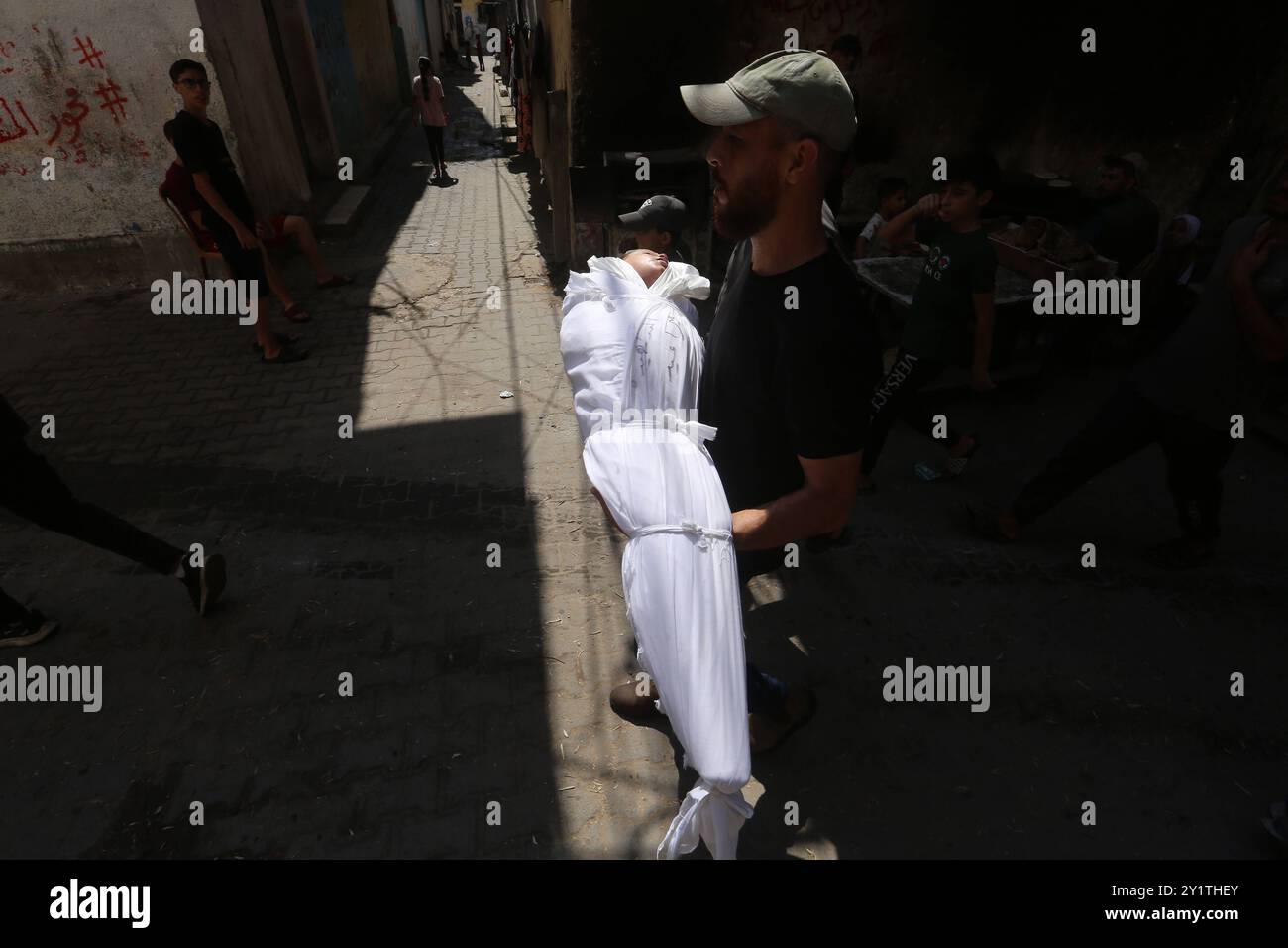 Mourners pray by the bodies of Mira Thaer Eid, 3, and Misk Hasan Eid, 5 ...