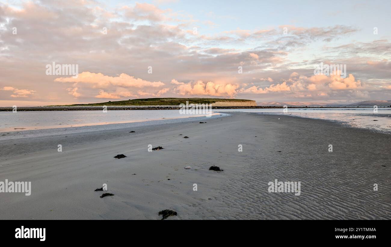 Dramatic coastal sunset landscape scenery with cliffs in background ...
