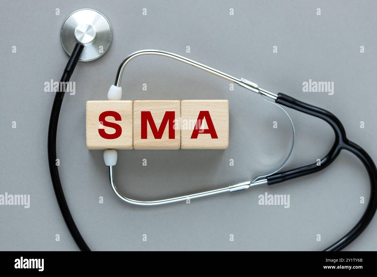 SMA, Spinal Muscular Atrophy. Medical stethoscope and acronym on wooden ...