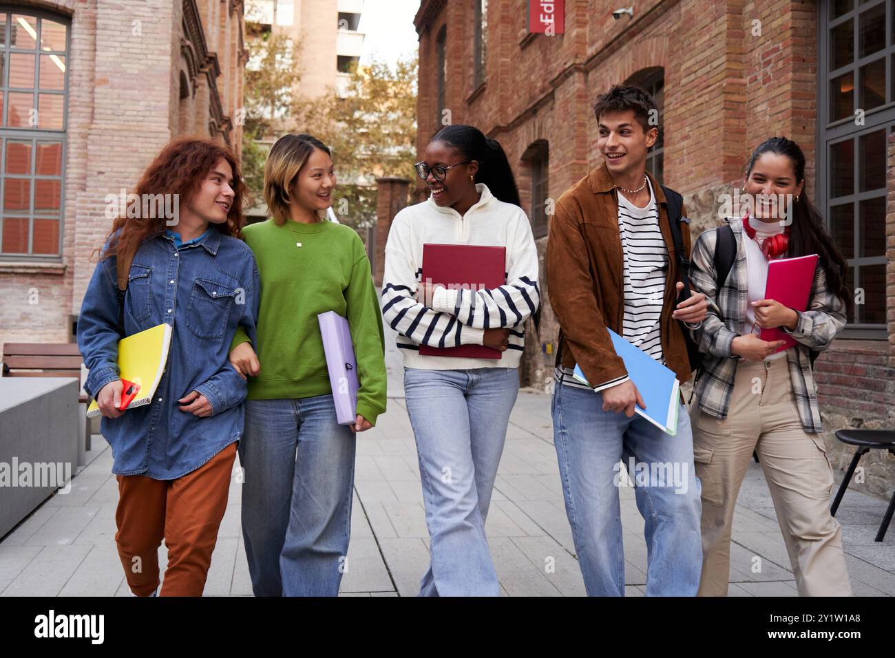 Internacional group of university students walking and talking at ...
