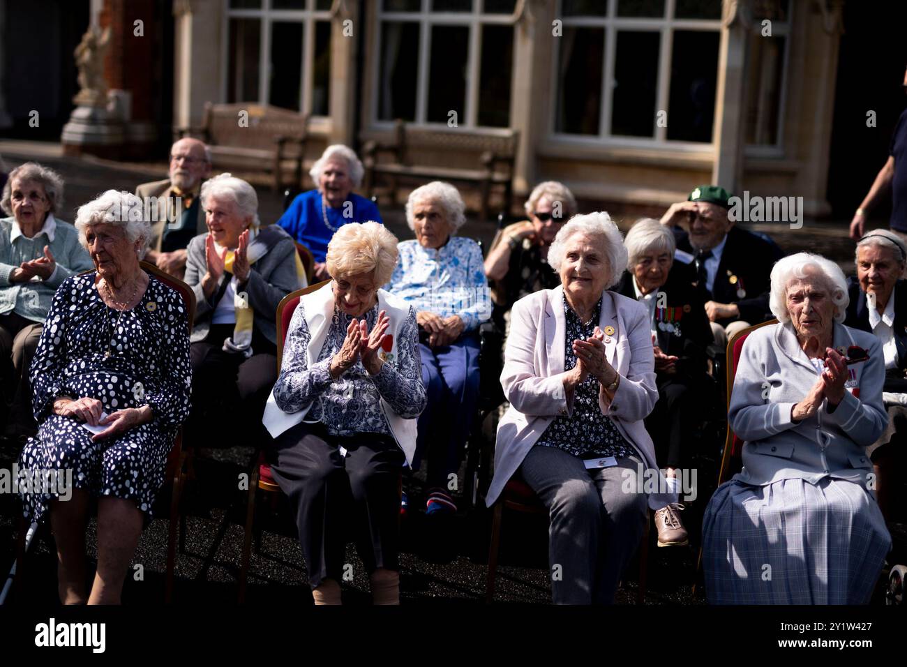Veterans pose for a group photograph infront of Bletchley Park Mansion ...