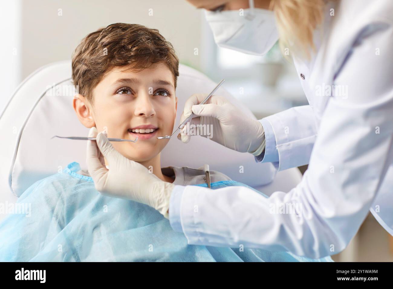 Dentist Checking Boy Patient Teeth During Medical Exam In Hospital ...