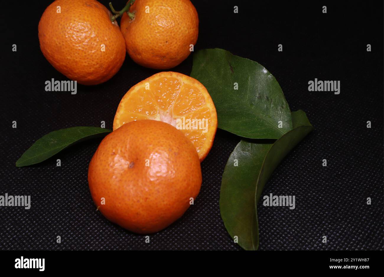 A vibrant citrus fruit, the bitter orange stands out against a stark ...