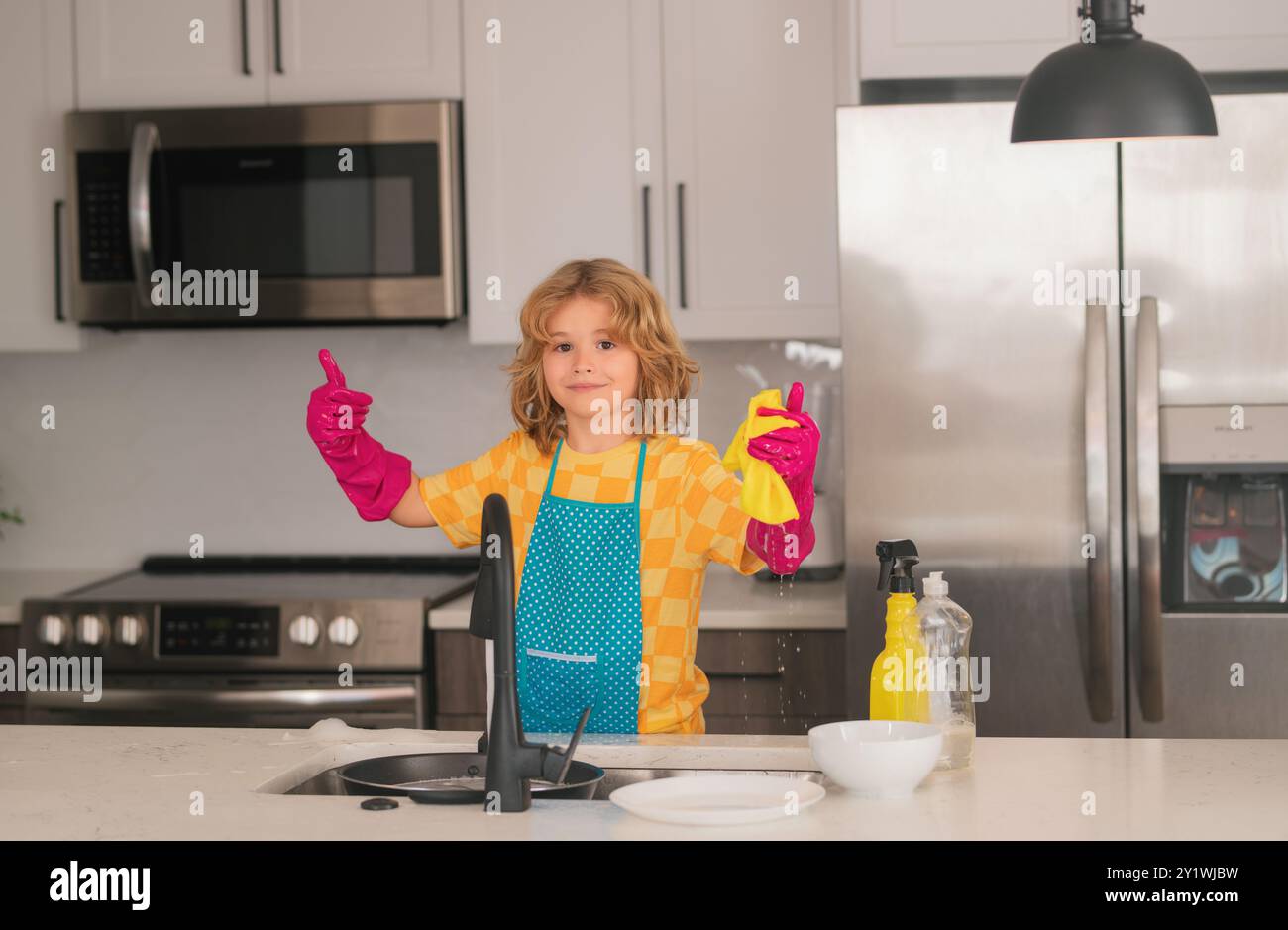 Child cleaning dishware kitchen sink sponge washing dish. Kid wiping ...