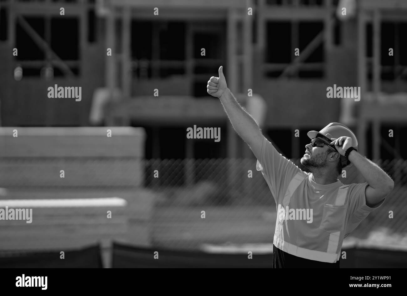 Construction man with helmet. American wood frame house construction ...