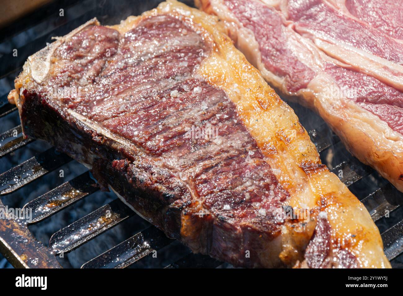 old cow steak cooking on the grill Stock Photo - Alamy