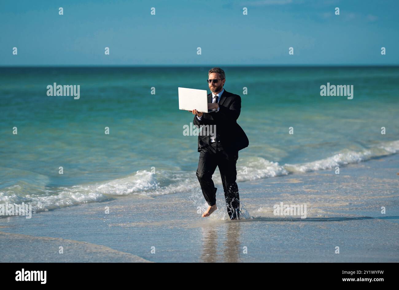 Businessman relaxing barefoot on beach hi-res stock photography and ...