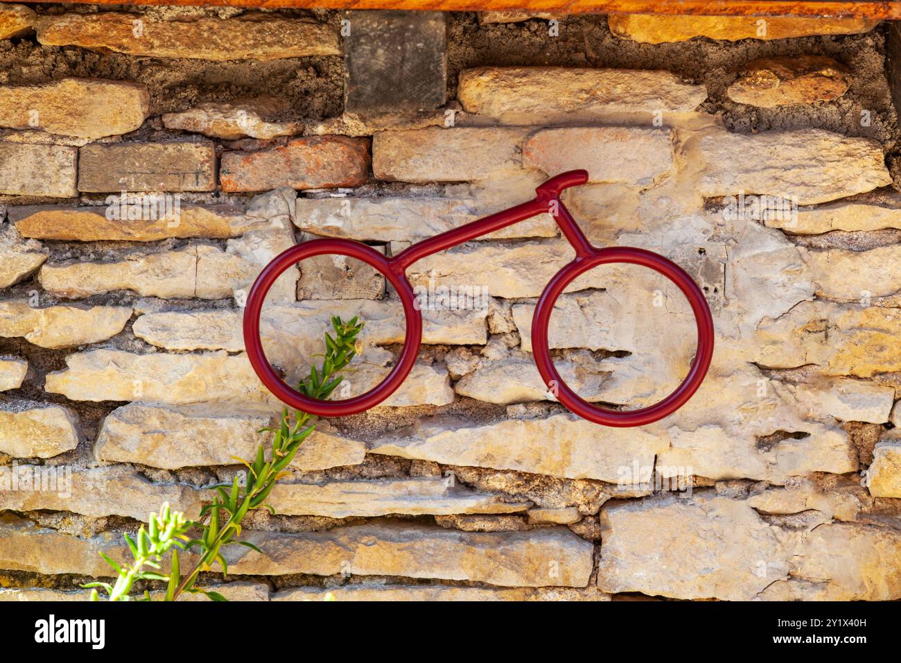 Decorative bicycle on a stone wall of a house in France Stock Photo - Alamy