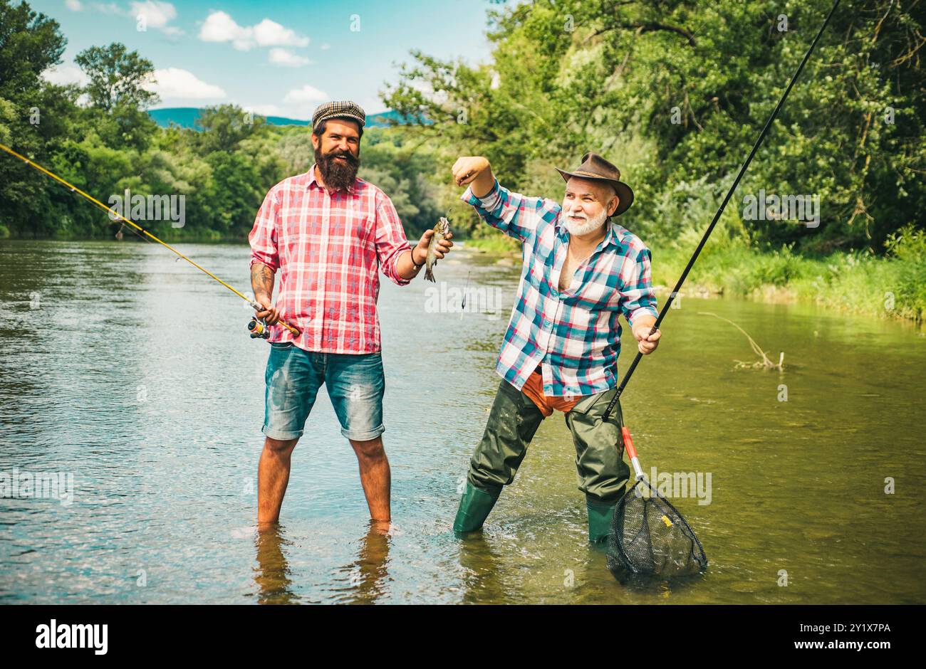 Man friends. Two men friends fishing. Flyfishing angler makes cast ...