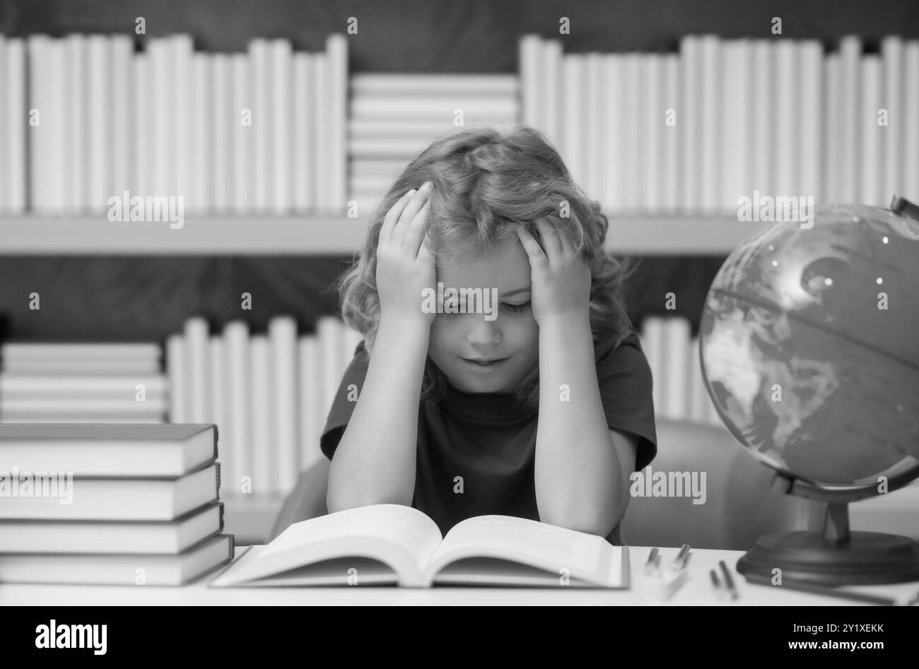 Tired school boy, bored pupil at school. School child pupil reading ...