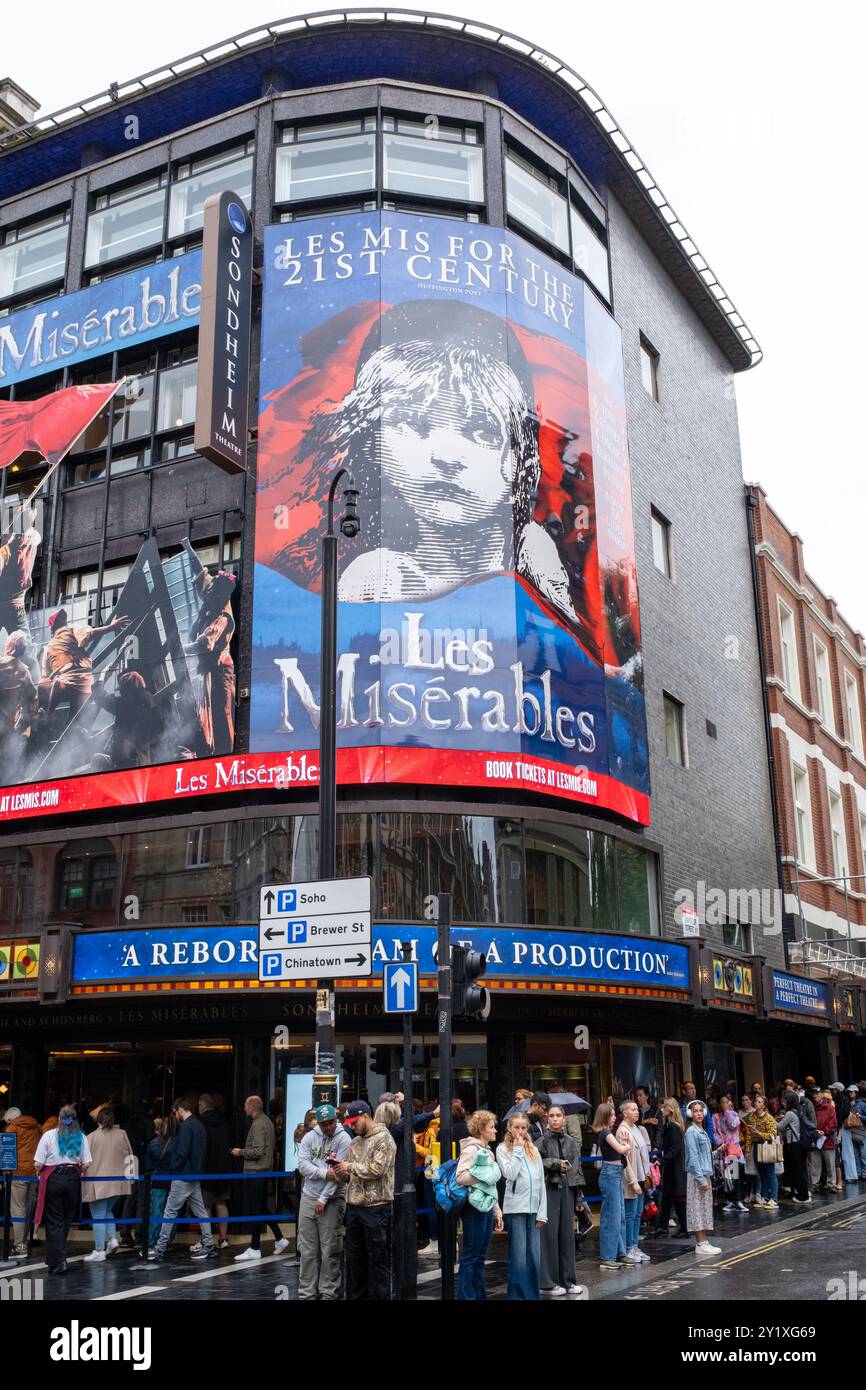 Theatre goers queuing outside teh Sondheim Theatre to see Les ...