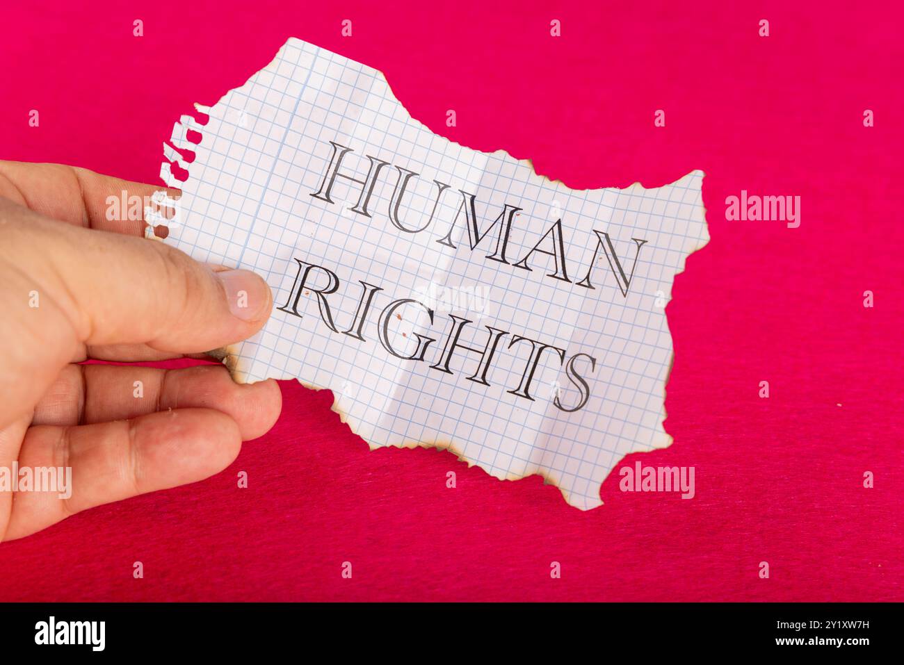A striking image of a hand grasping a paper with "Human Rights" printed ...