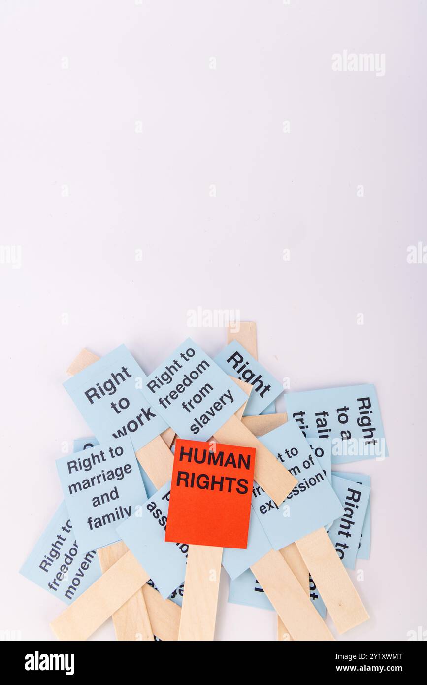 Bright blue signs with scattered human rights messages and a bold red ...