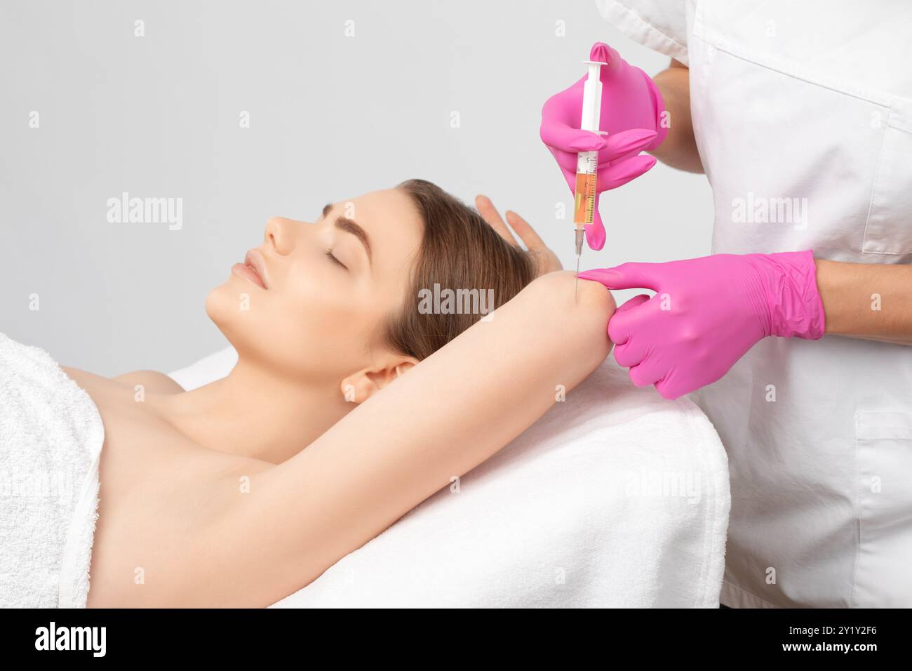 Doctor doing stem cell therapy on a patient's elbow after the injury. Treating knee pain with ...