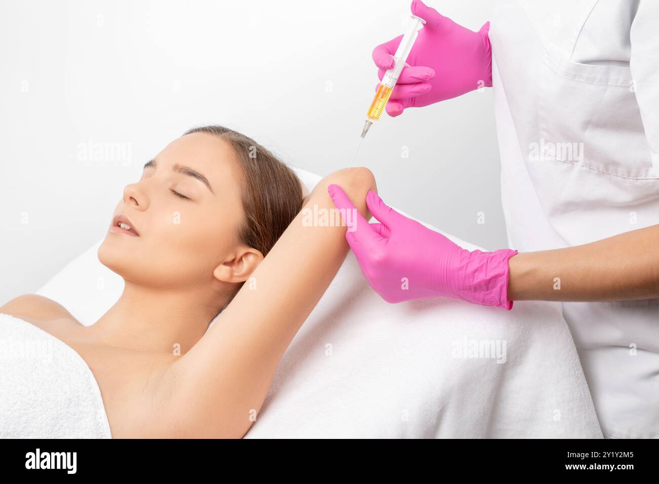 Doctor doing stem cell therapy on a patient's elbow after the injury. Treating knee pain with ...