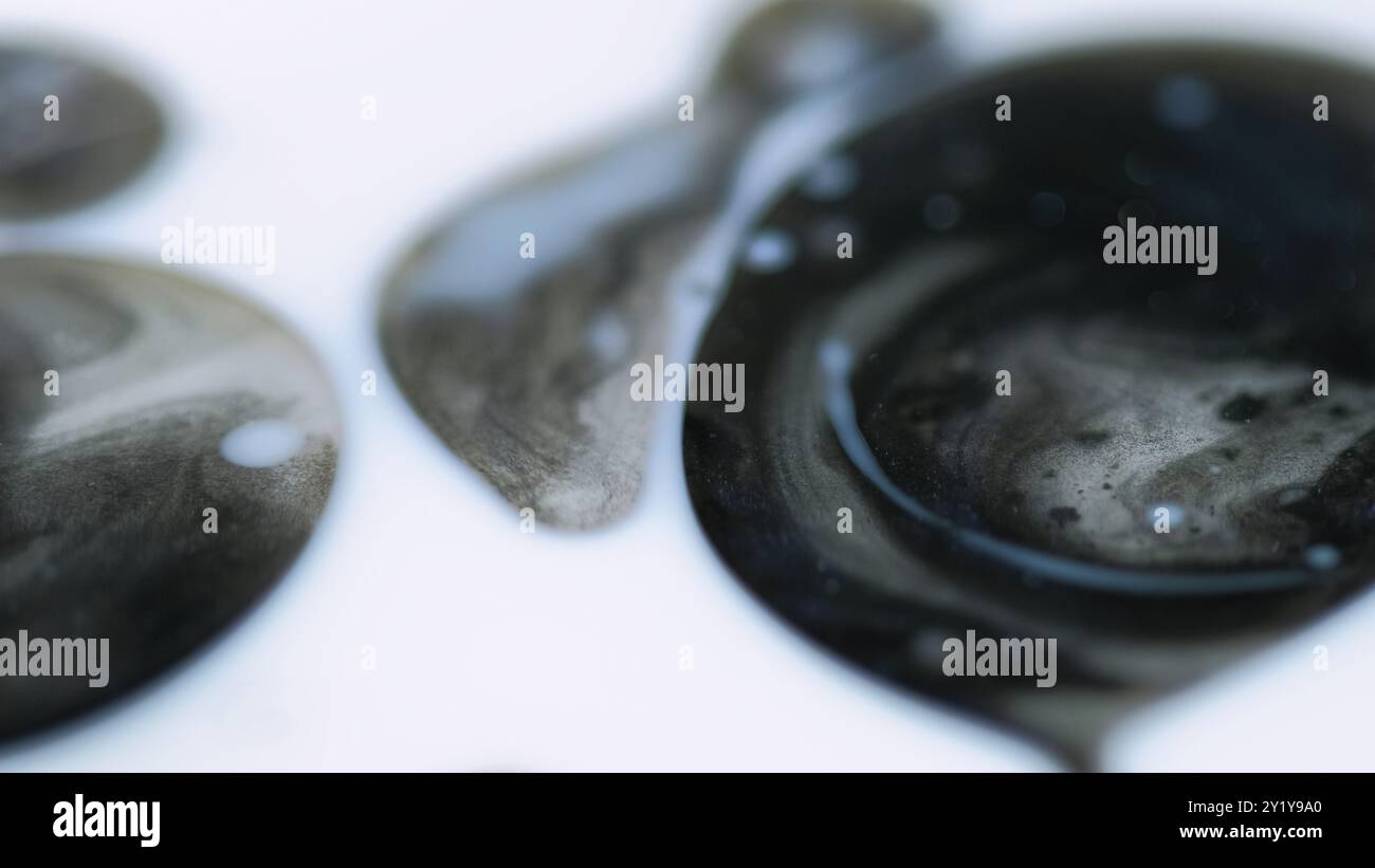 Ink water drop. Shimmering liquid. Blob paint. Defocused black white ...