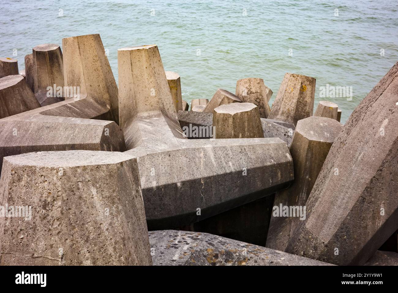 man made concrete sea wall defence defending the shore from the power ...