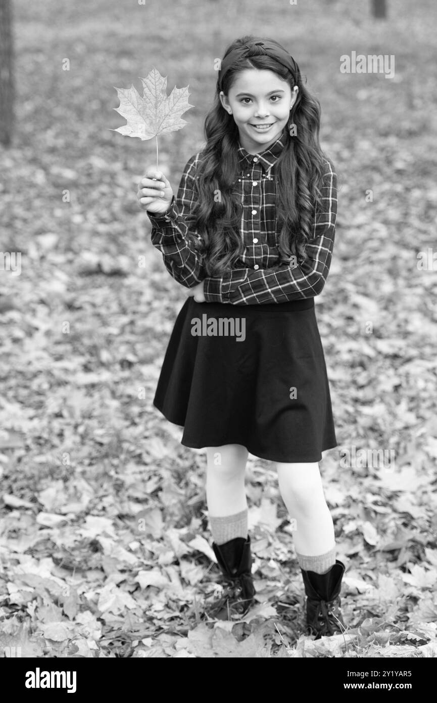 teen girl in school uniform hold autumn leaf. happy child having fun ...