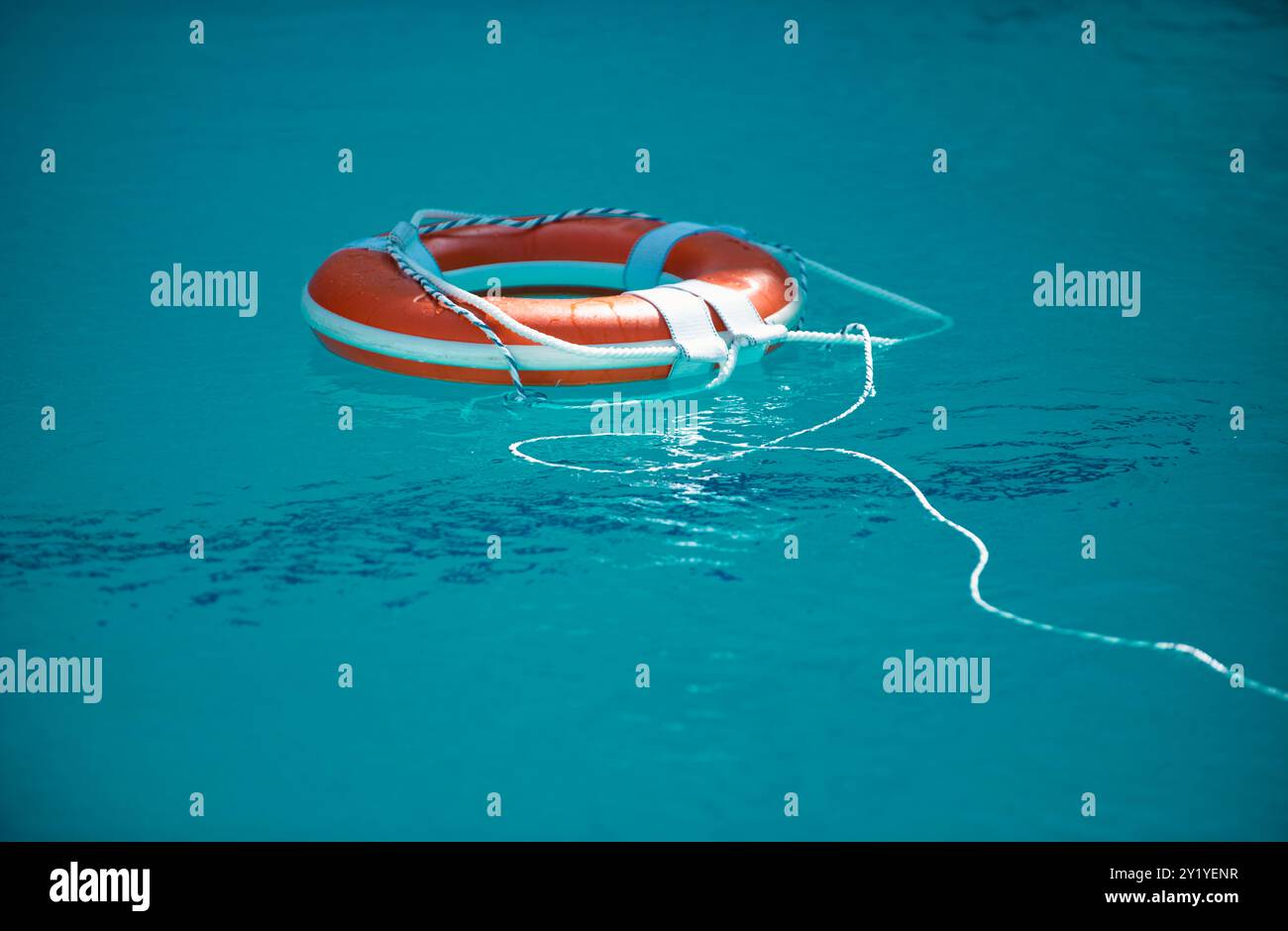 Life buoy in blue swimming pool. Lifebuoy pool ring float on blue water ...