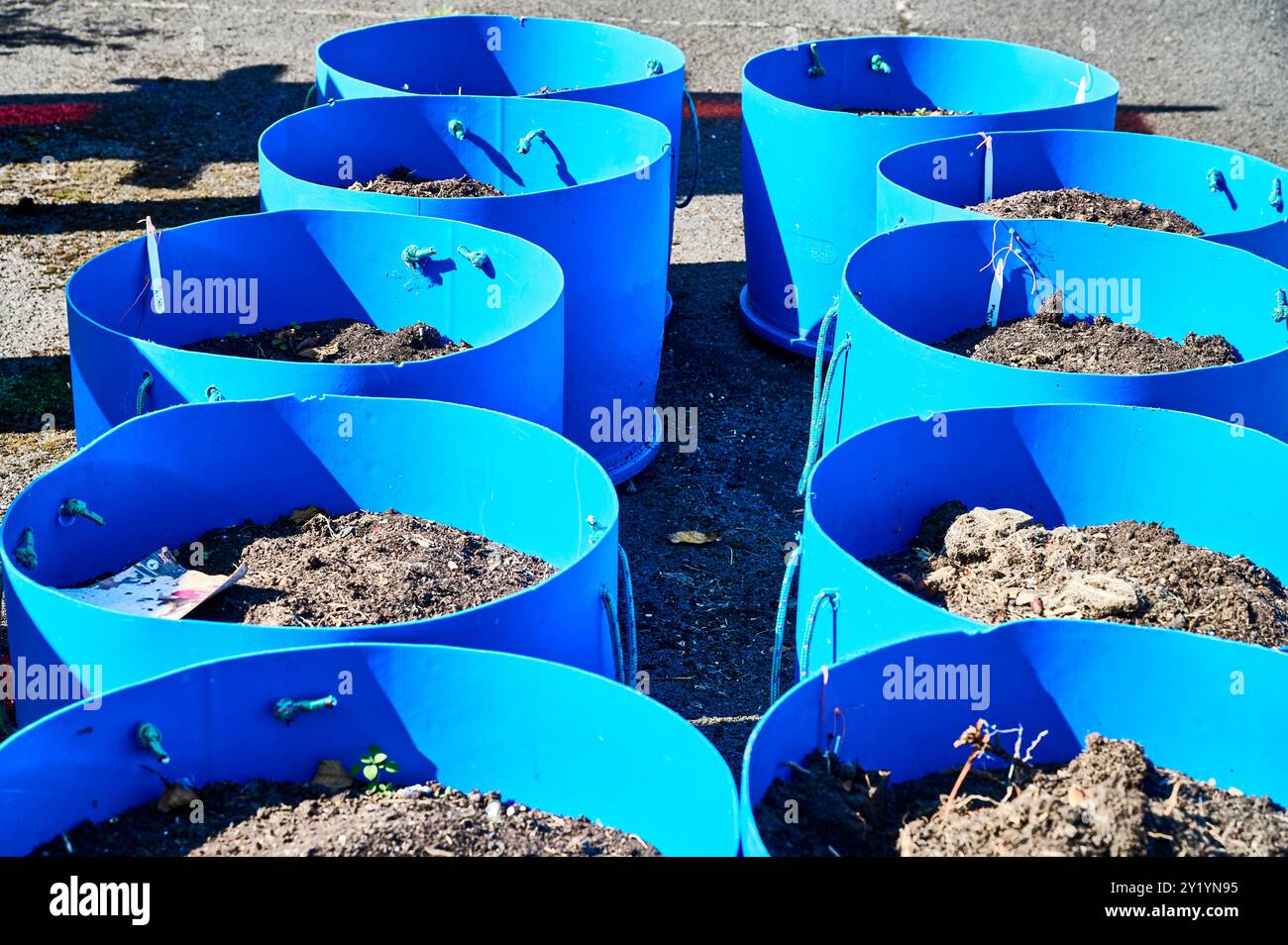 Plastic round containers containig soil Stock Photo - Alamy