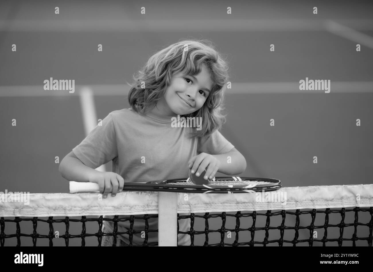 Child playing tennis on indoor court. Little child with tennis racket ...