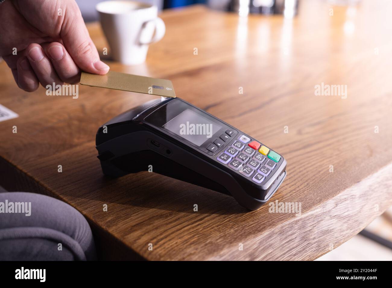 NFC credit card payment. Woman paying with contactless credit card with ...