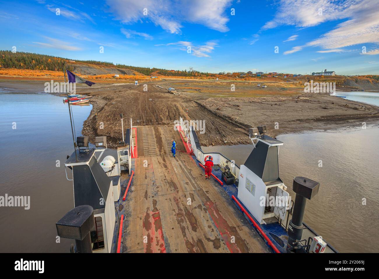 The Mackenzie River ferry arriving at the village of Tsiigehtchic ...