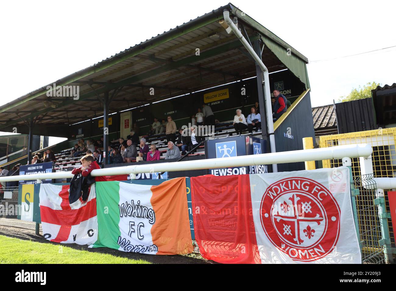 Fans flags in front of family stand Woking FC Women v Abbey Rangers FC ...