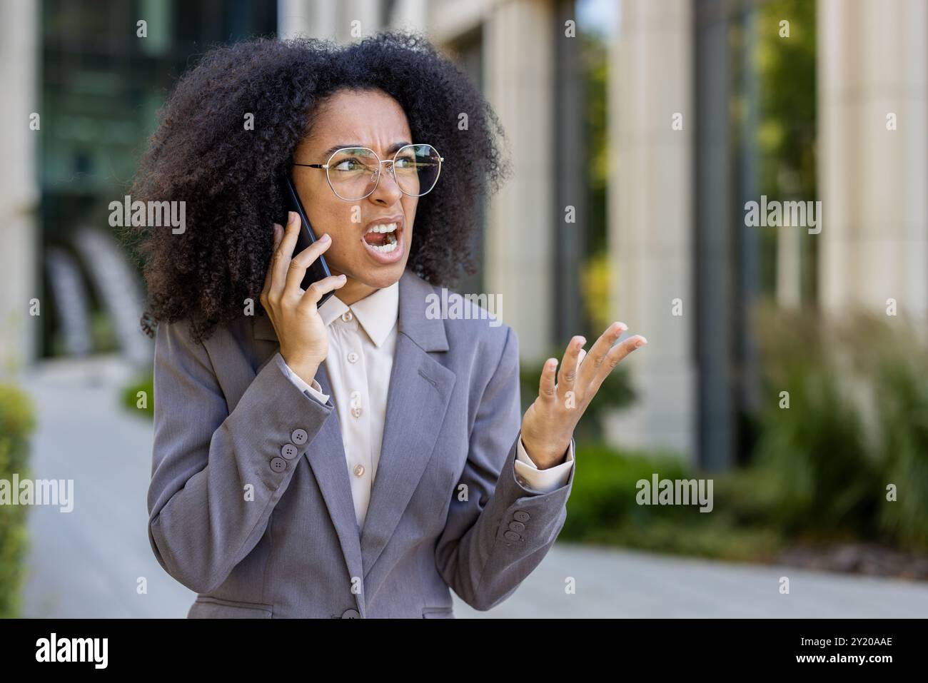 African American businesswoman experiencing frustration during phone ...