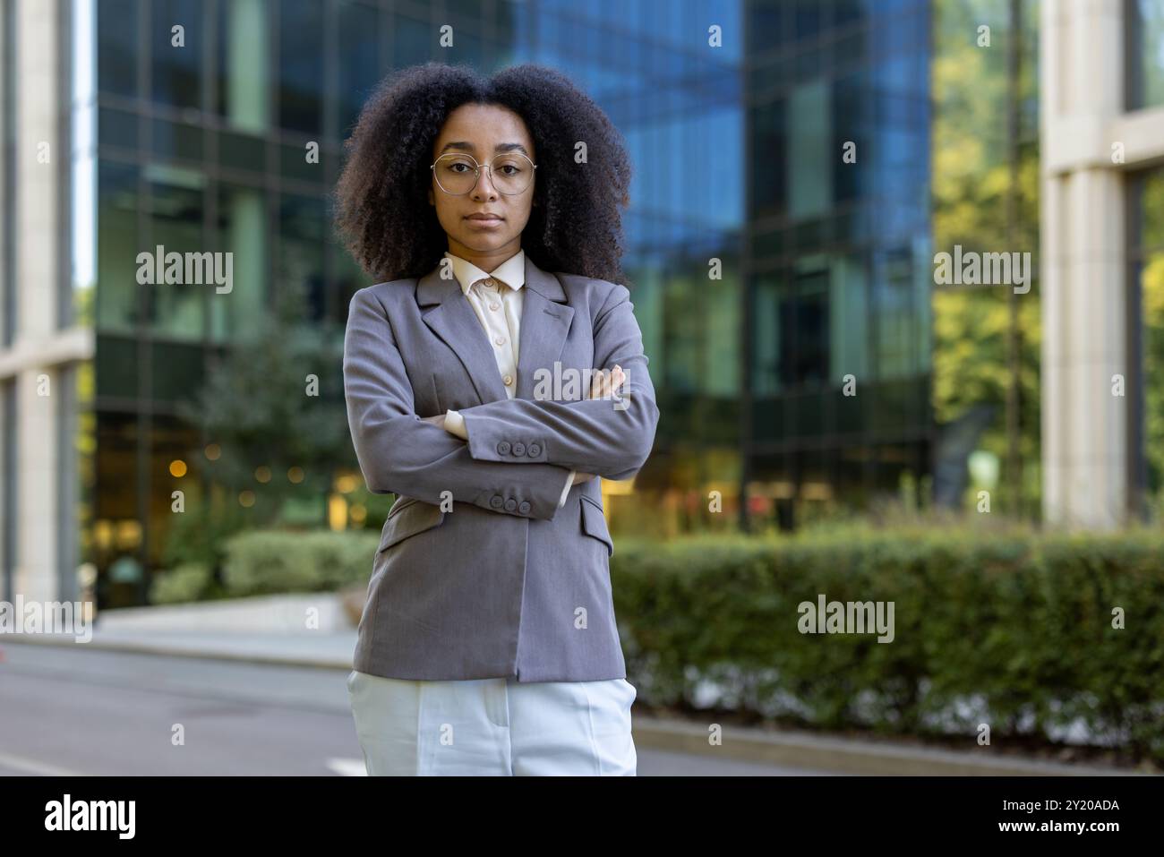 Confident African American businesswoman stands with arms crossed ...