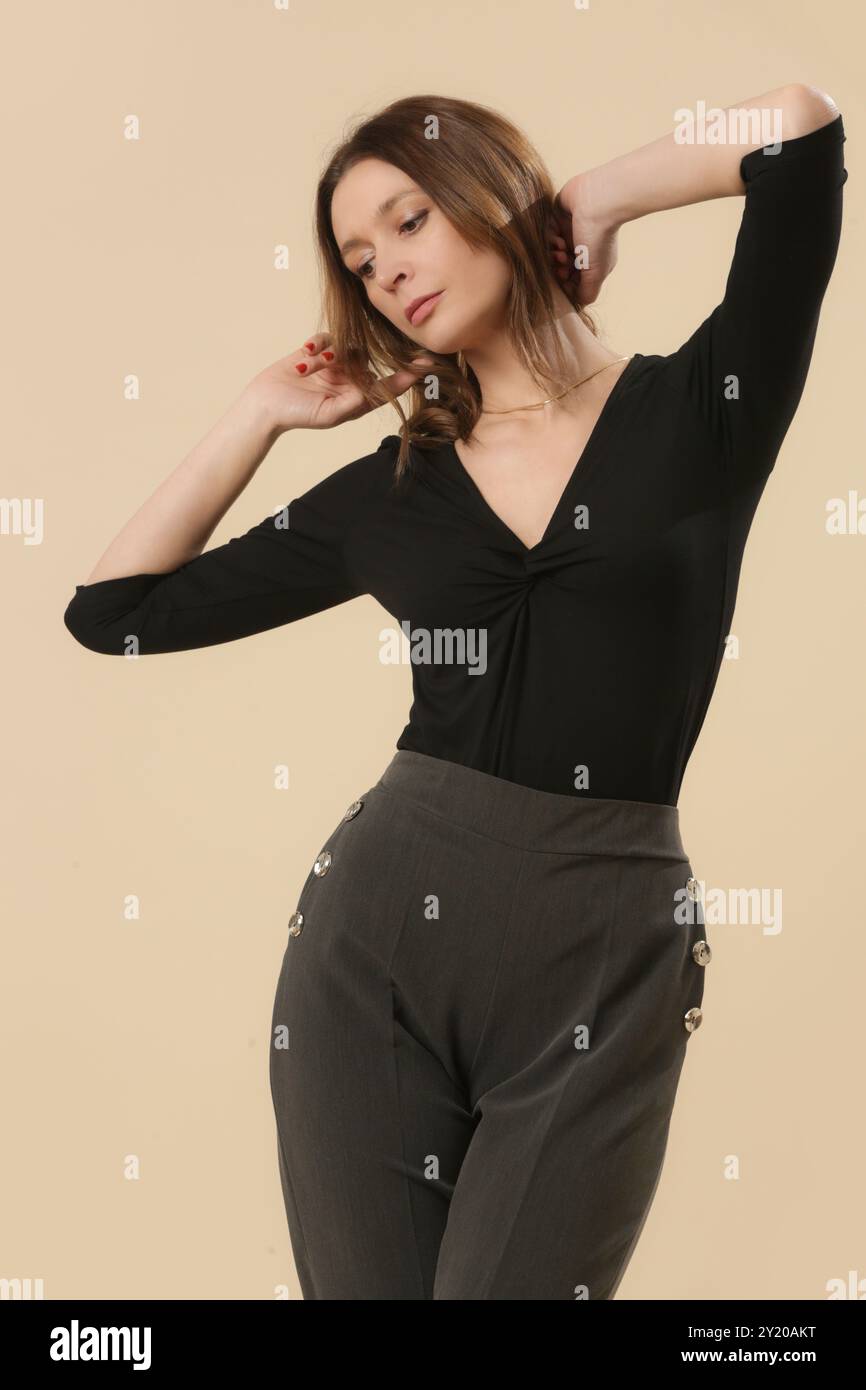 Serie of studio photos of young female model wearing simple comfortable ...