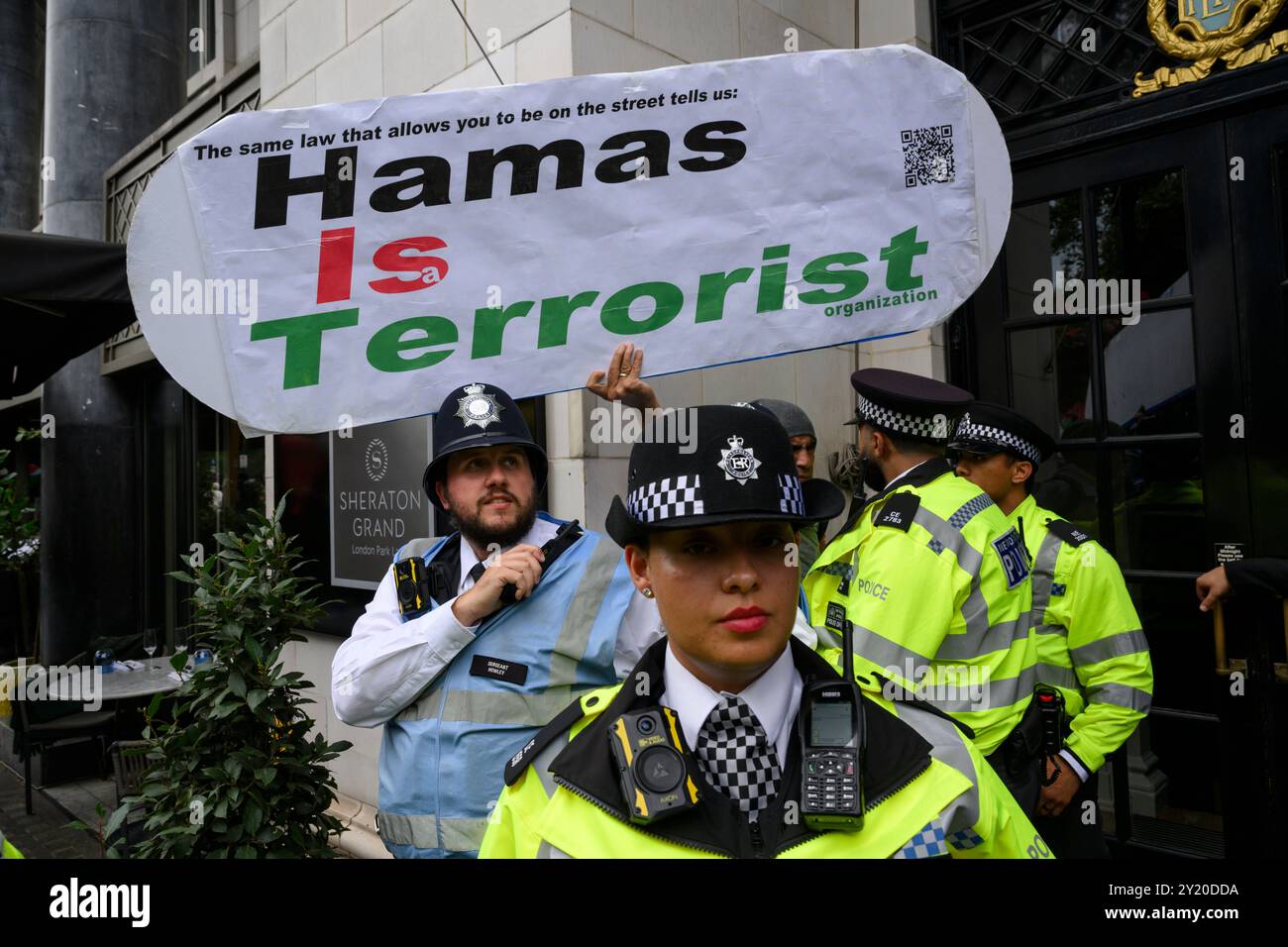 A lone counter-protester holding up a placard saying “Hamas is a ...
