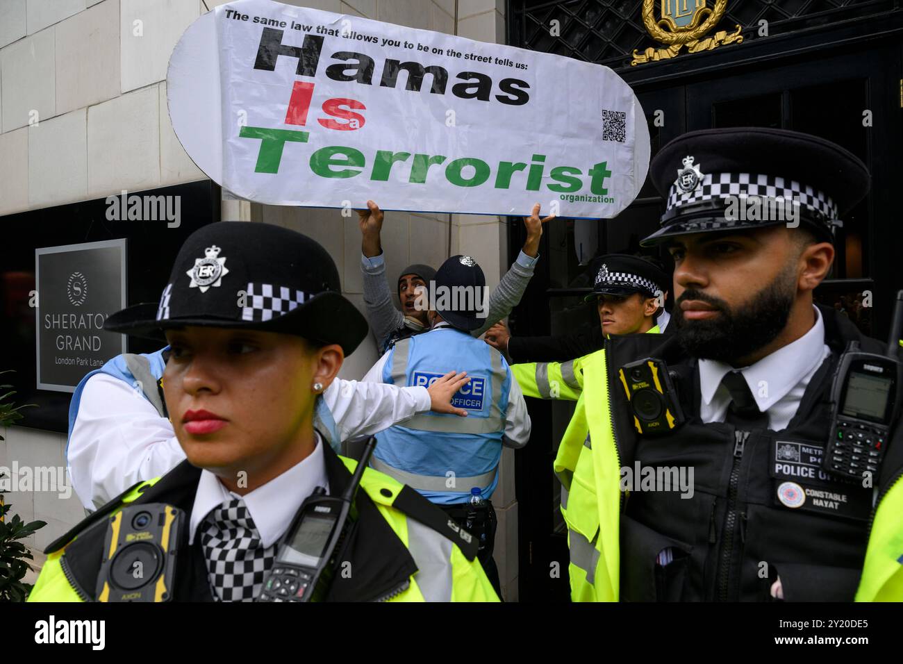 A lone counter-protester holding up a placard saying “Hamas is a ...