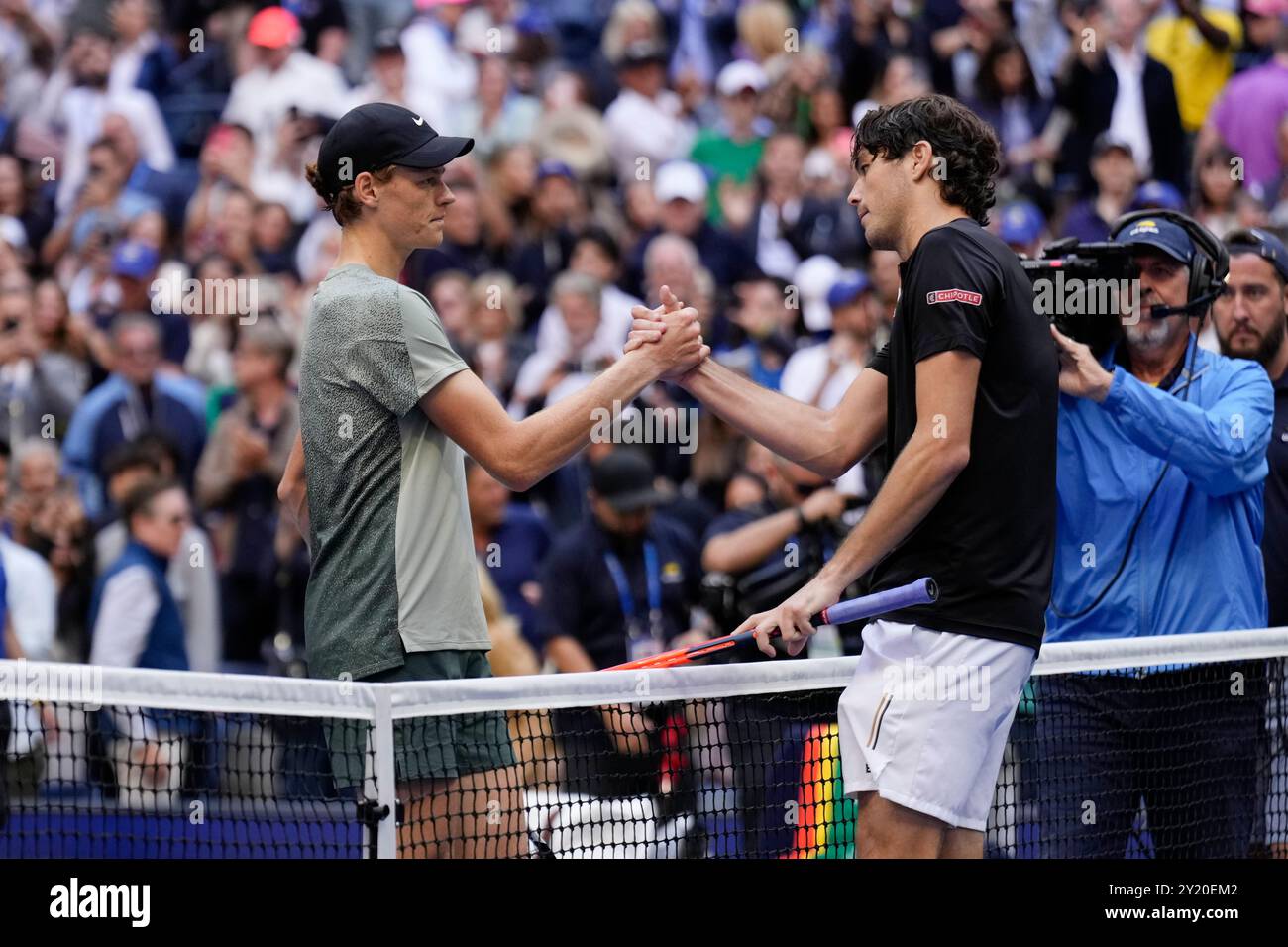 Jannik Sinner, left, of Italy, greets Taylor Fritz, of the United ... Jannik Sinner, left, of Italy, greets Taylor Fritz, of the United ...