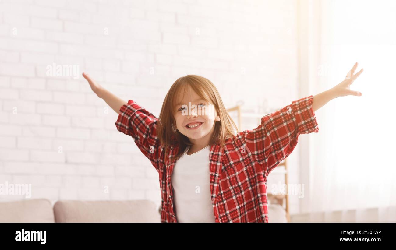 Joyful little girl raising hand hi-res stock photography and images - Alamy
