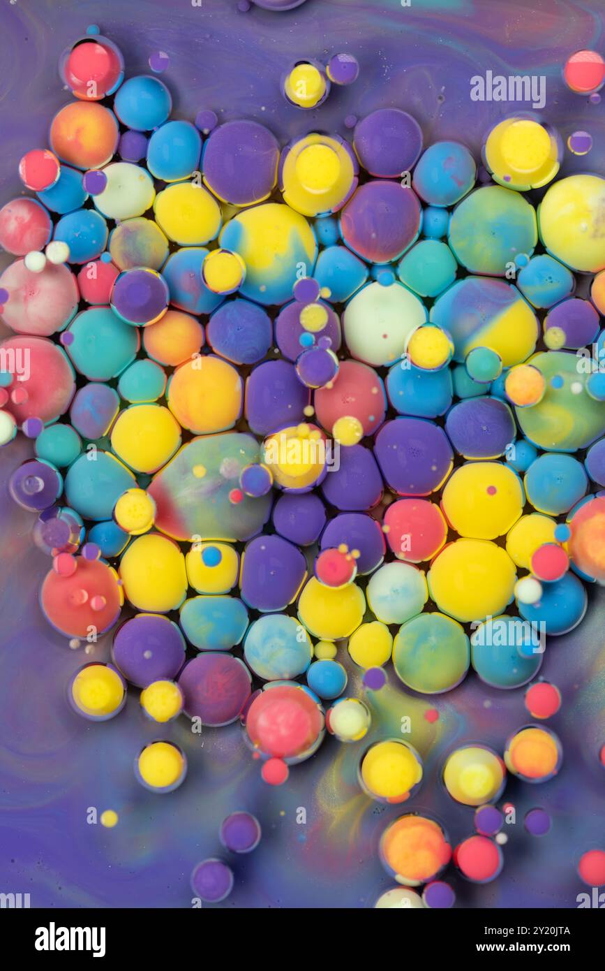 Colorful patterns of floating spheres on a vibrant purple background ...